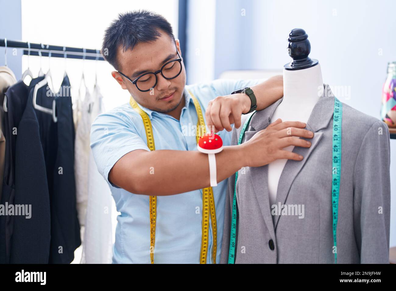 Serious handsome tailor sewing hi-res stock photography and images - Alamy