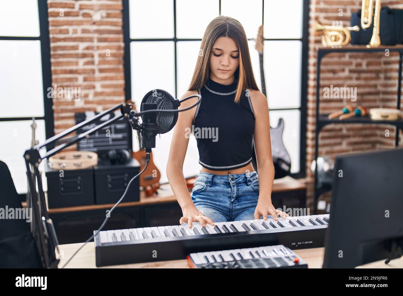Adorable girl musician singing song playing piano keyboard at music ...