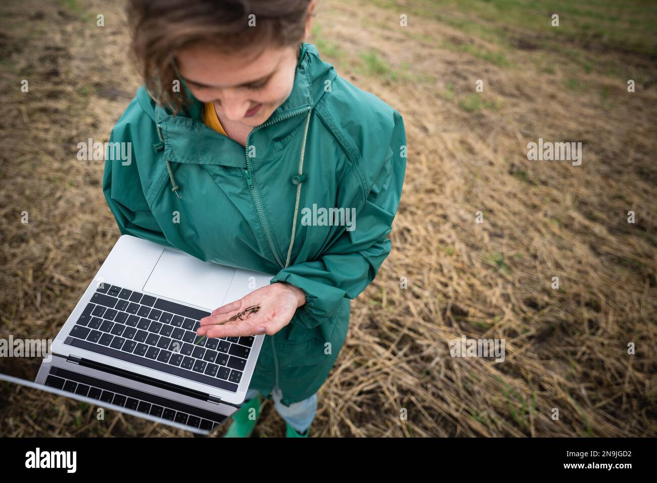 Farmer with laptop on the field. Smart farming and agriculture ...
