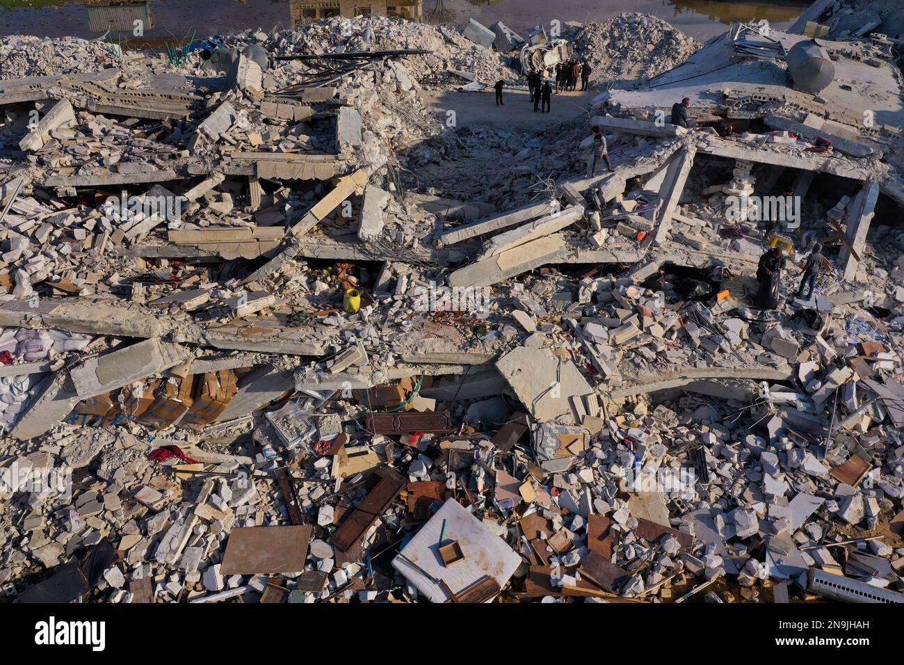 Rescue workers continue to clear rubble from collapsed houses in ...