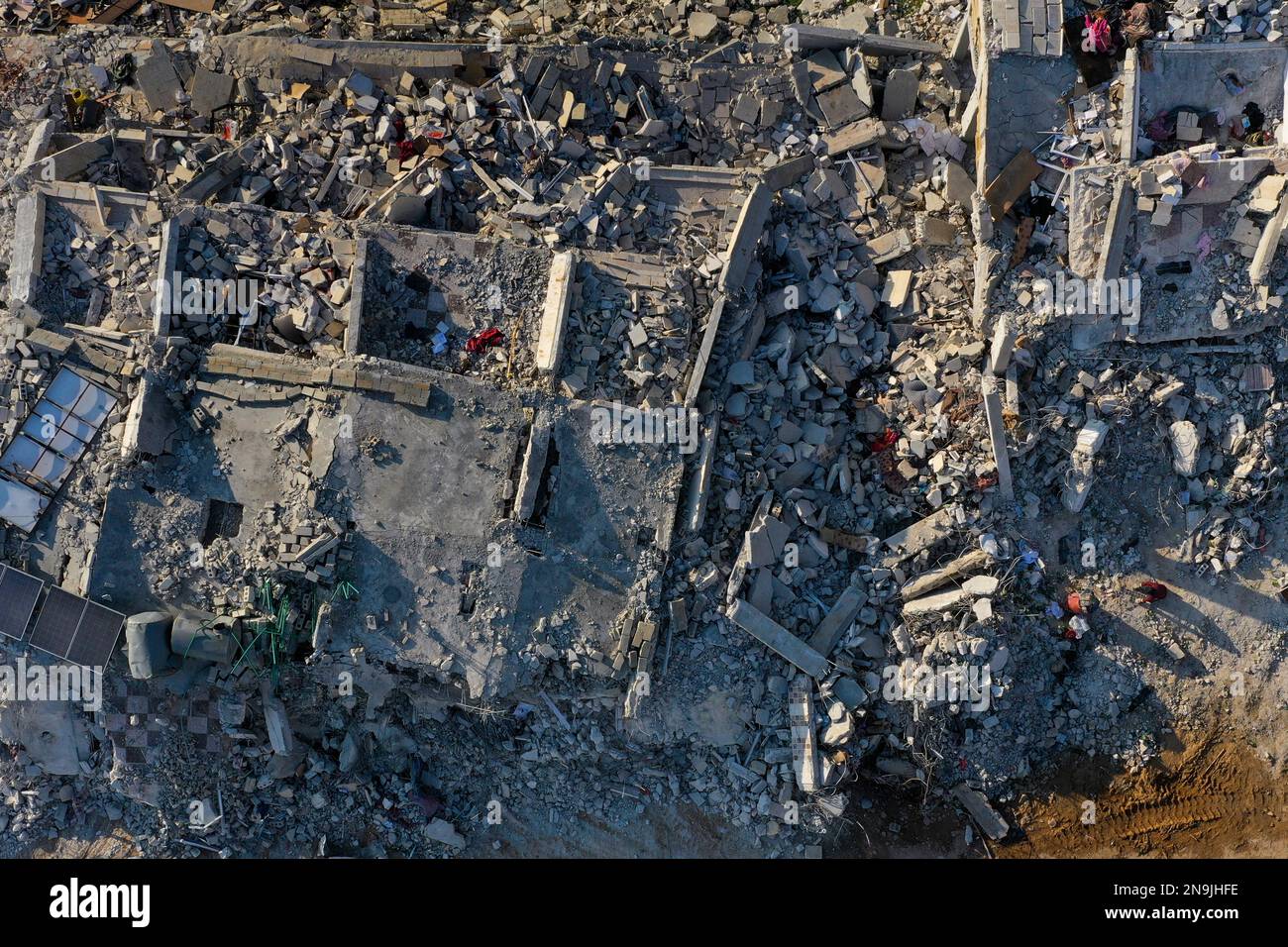 Rescue workers continue to clear rubble from collapsed houses in ...