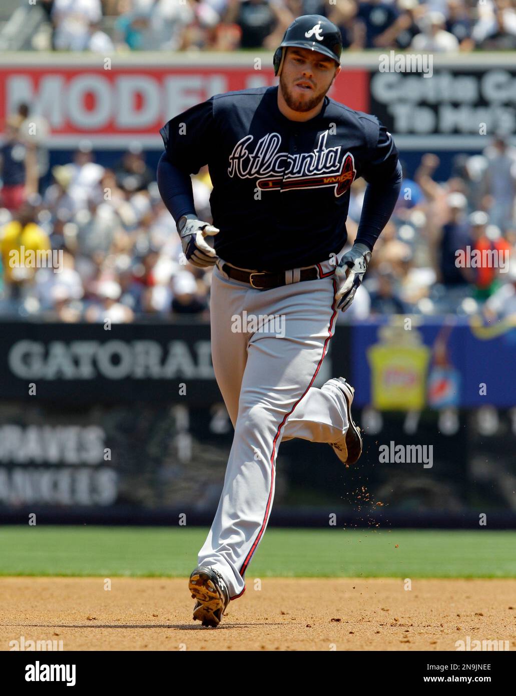 Atlanta Braves' Freddie Freeman trots around the bases after hitting a ...