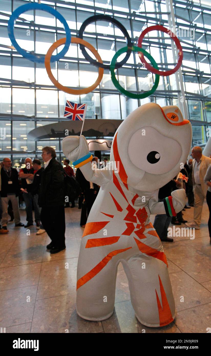 The London 2012 Olympic mascot Wenlock poses under giant Olympic Rings ...