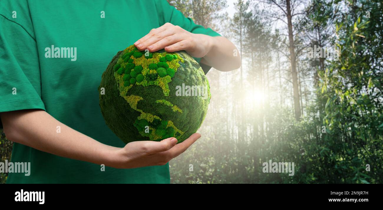 Woman holds a green planet Earth. Symbol of sustainable development and ...