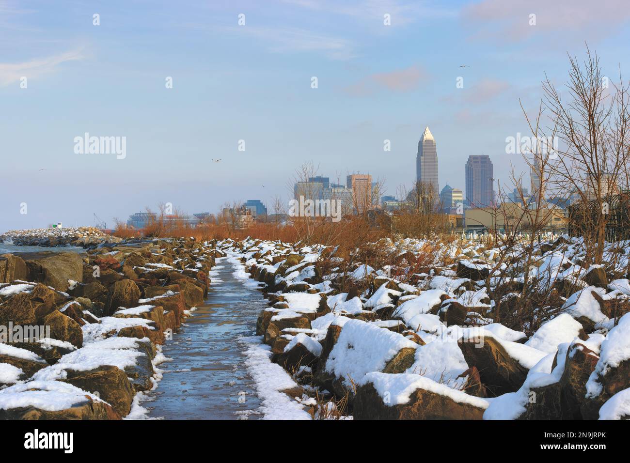 Views of Cleveland's skyline along the wintery shoreline of Lake Erie ...