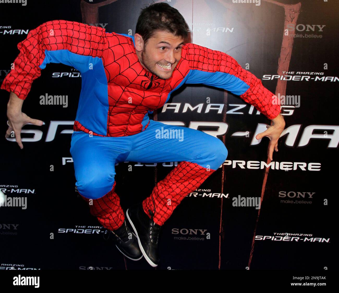French TV journalist Christophe Beaugrand in Spiderman costume jumps as ...