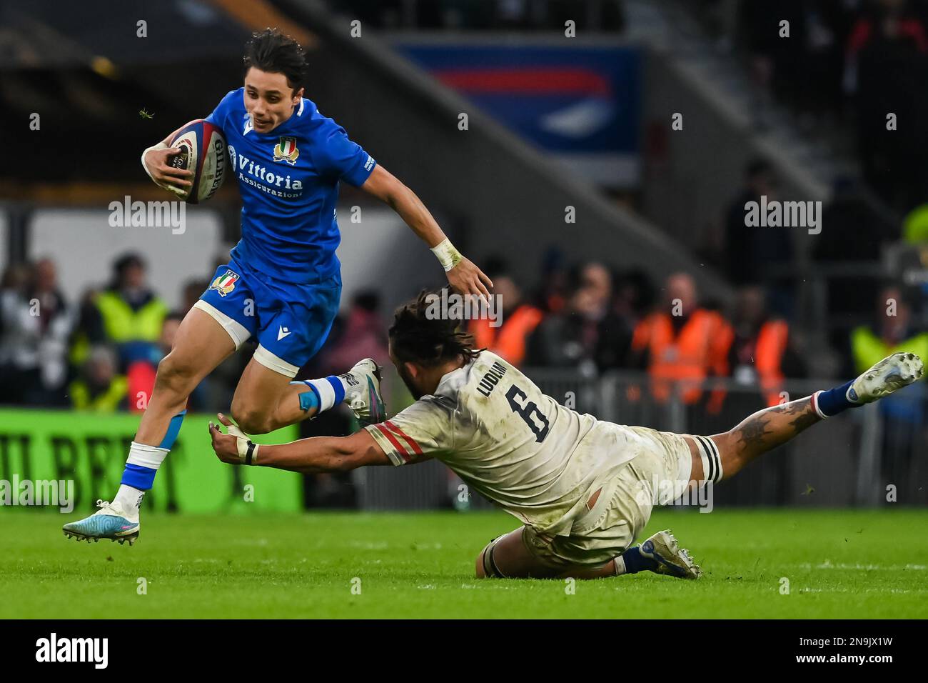 Ange Capuozzo of Italy evades the tackle of Lewis Ludlam of England ...