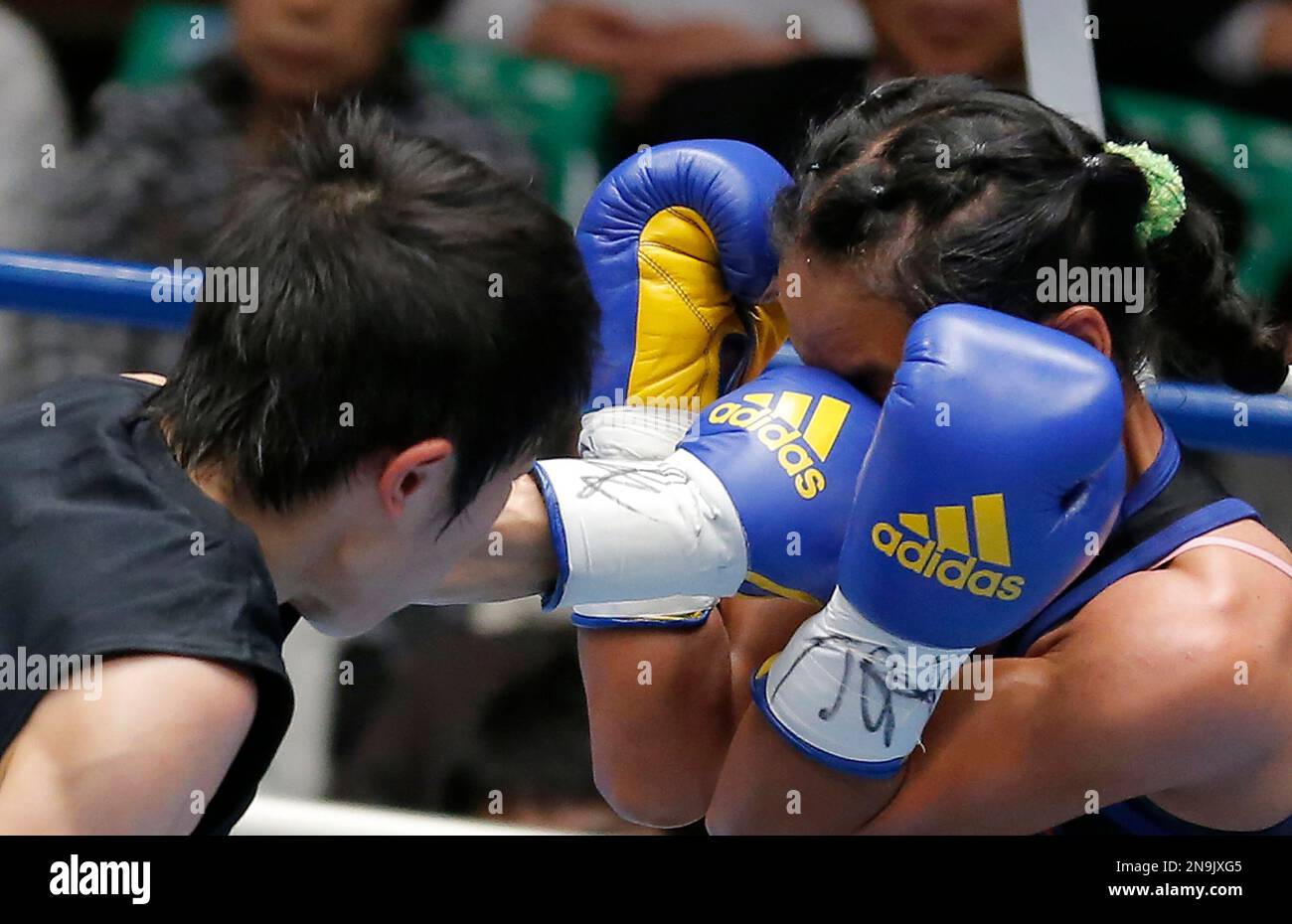 Japanese champion Momo Koseki, left, sends a left to Philippine ...
