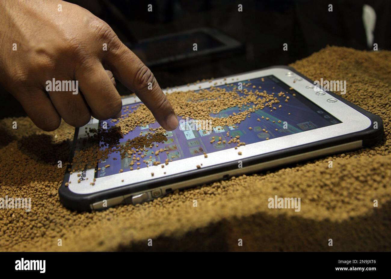 Panasonic's employee demonstrates its new TOUGHPAD, boasting to be the ...