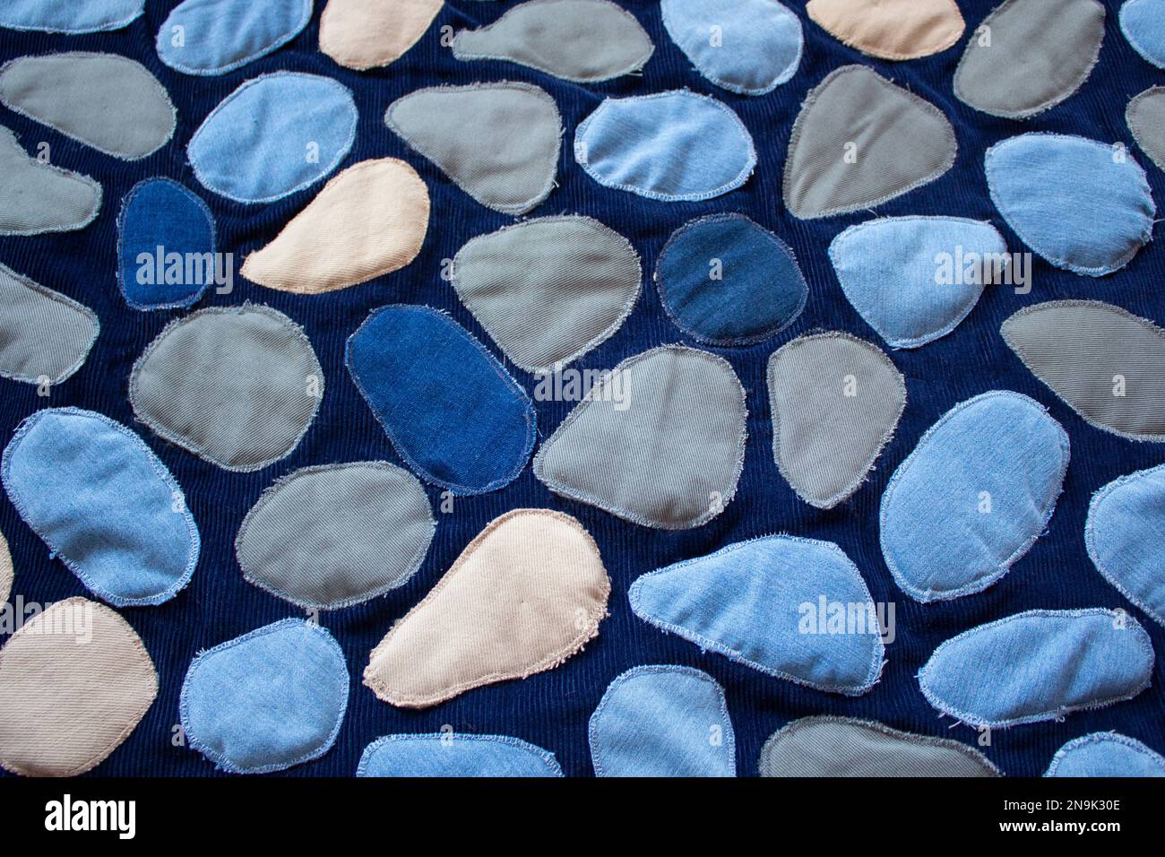 Denim background, patchwork texture. Imitation sea pebbles, patchwork ...