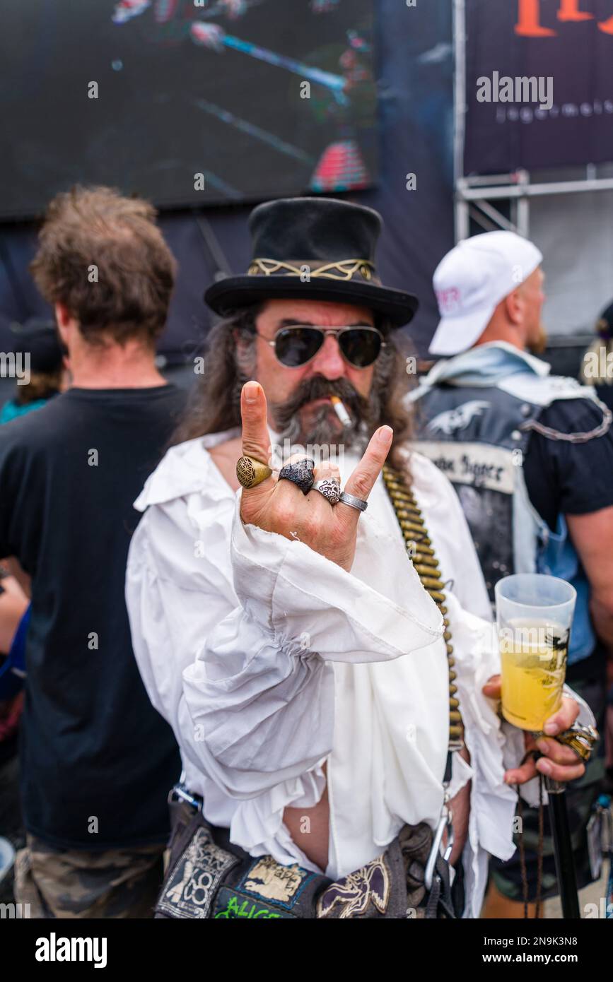 A vertical shot of an older male rocking out at the Brutal Assault 2022 ...