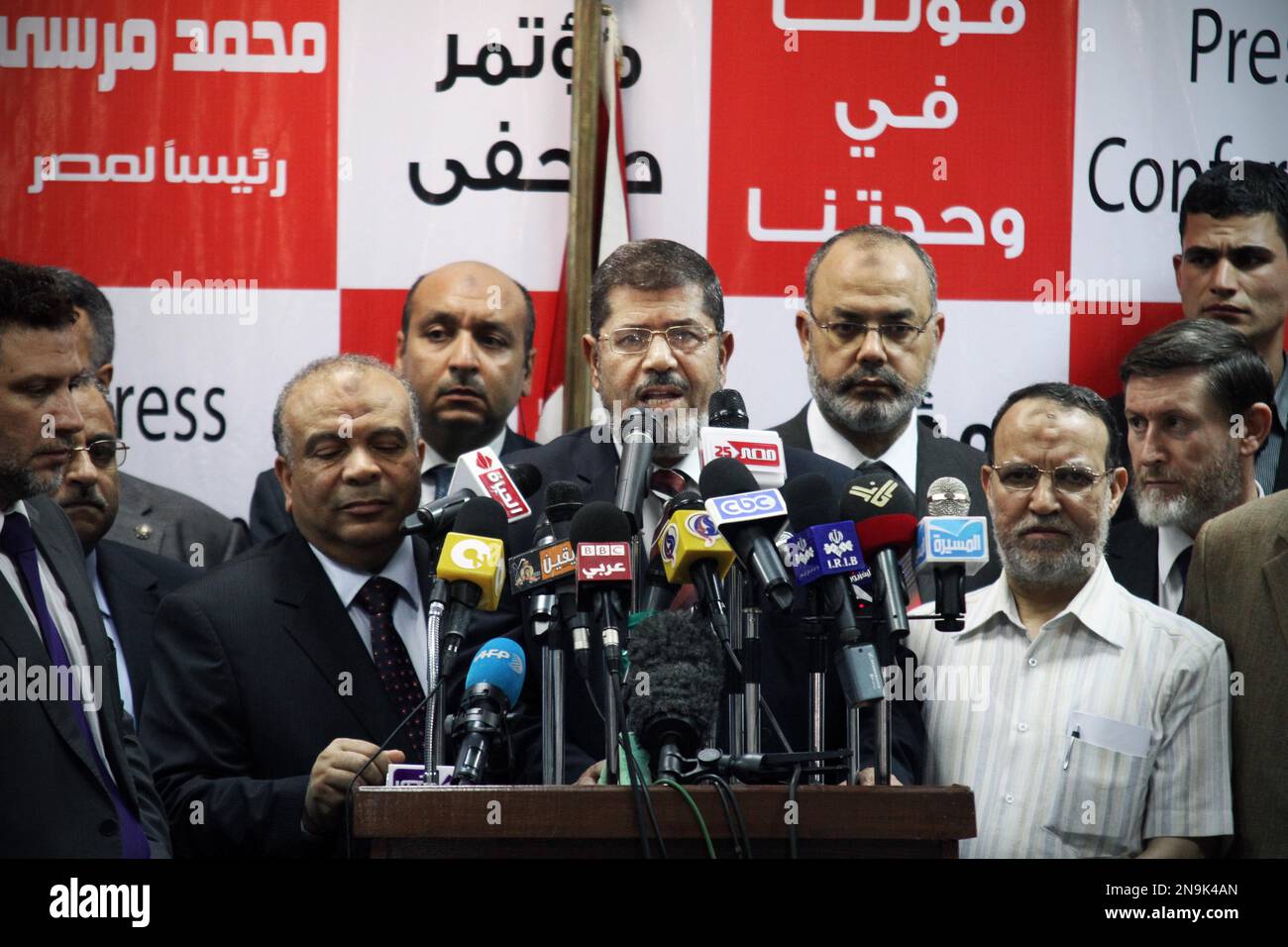 Mohammed Morsi, center, speaks during a press conference after his ...