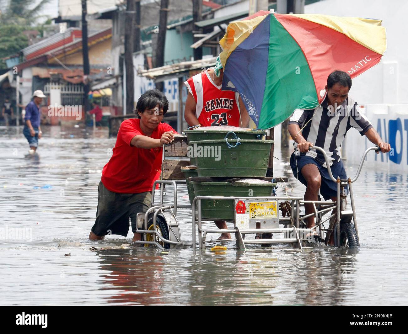 Residents go on their daily business amidst flooding Monday, June 18 ...
