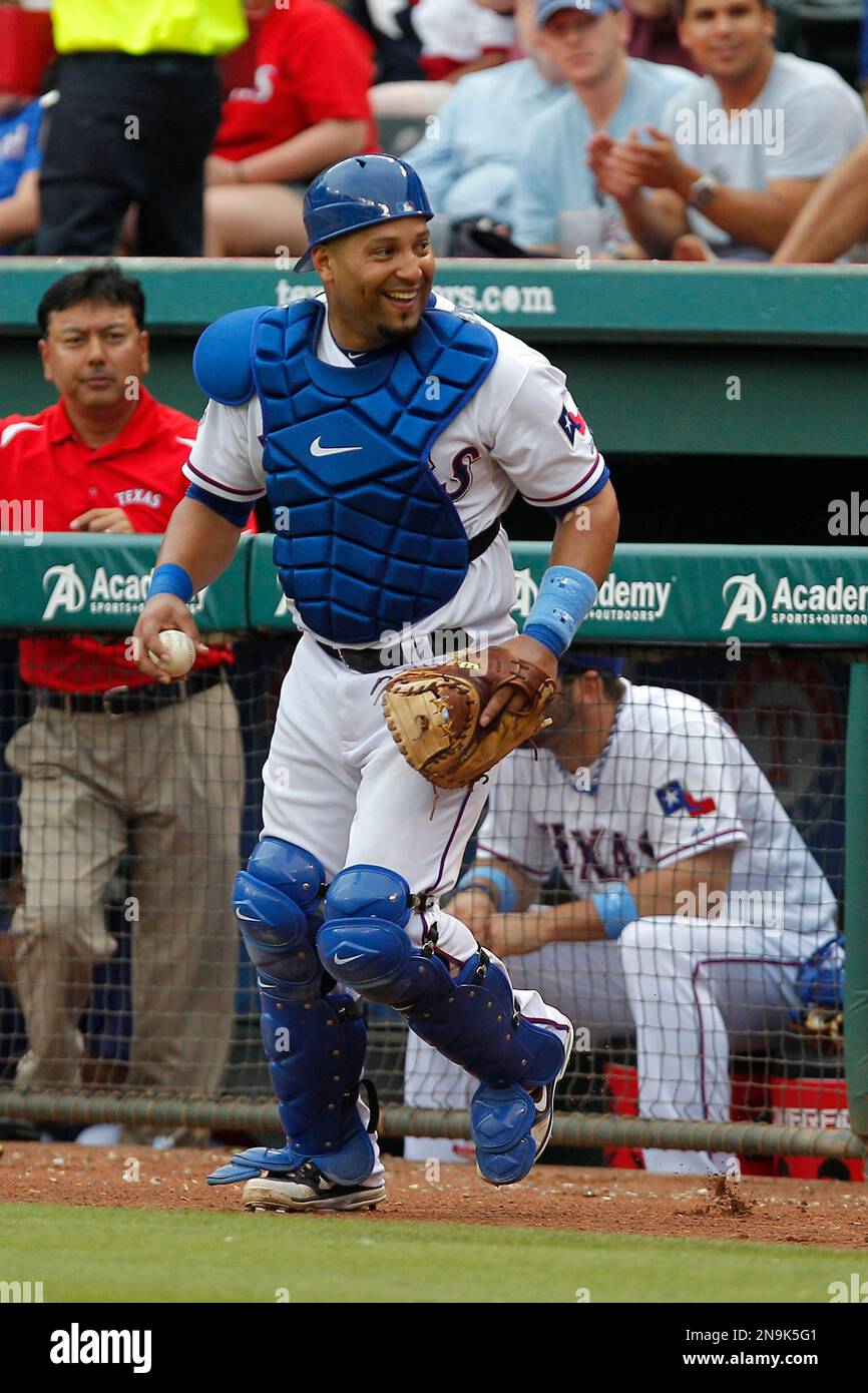 Texas Rangers catcher Yorvit Torrealba smiles after catching a ball ...