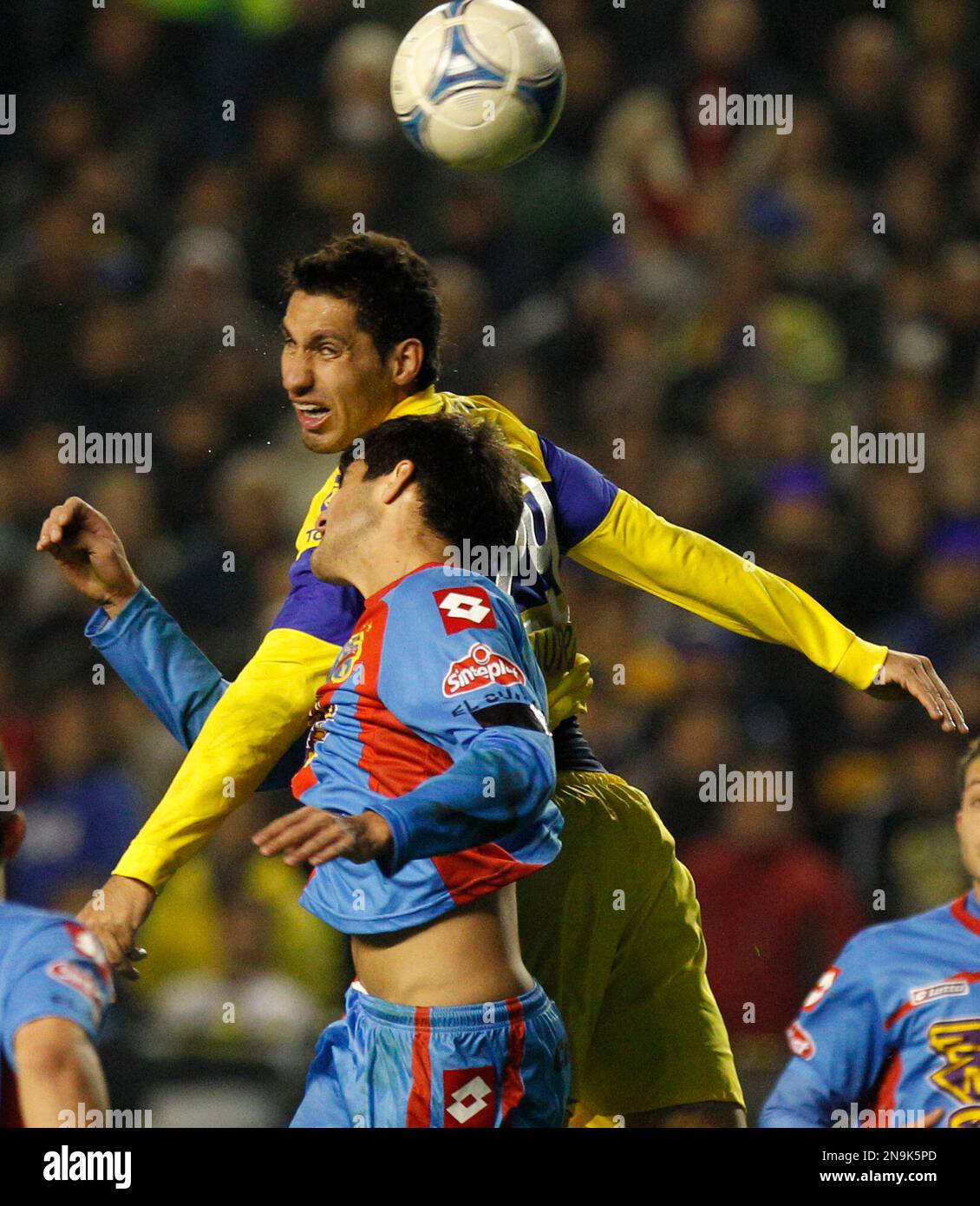 Boca Juniors' Juan Insaurralde and Lisandro Lopez of Arsenal go for a ...