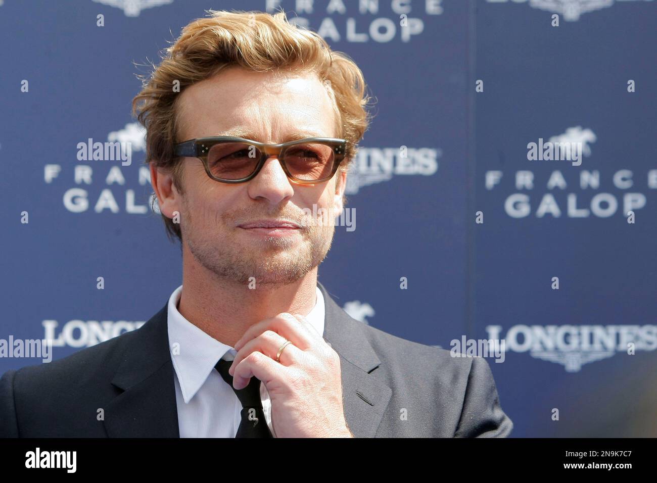 Australian actor Simon Baker poses prior to the Prix de Diane horse ...