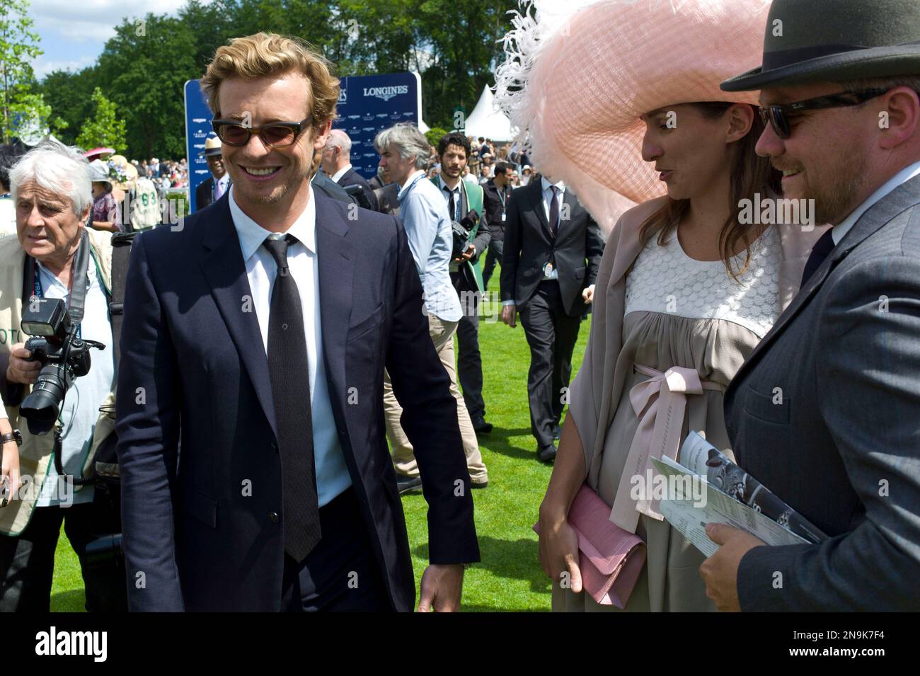 Australian actor Simon Baker, second left, is seen prior to the Prix de ...
