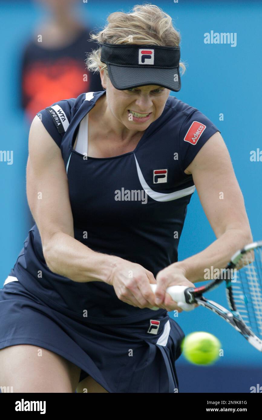 Kim Clijsters of Belgium returns in her match against Romina Oprandi of ...