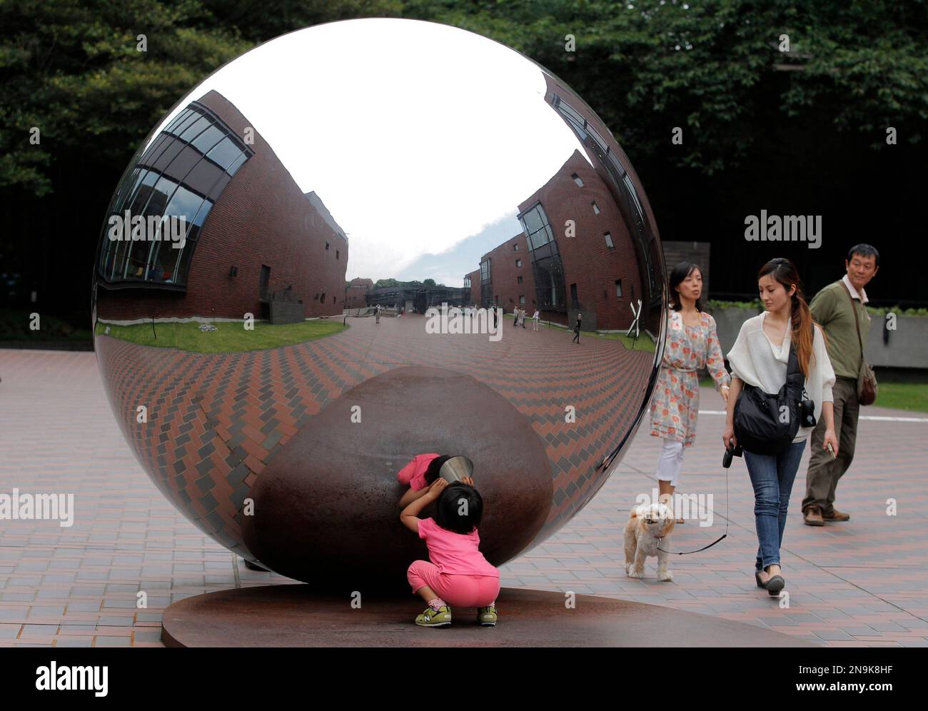A child peeks inside a hole of a sculpture at Tokyo Metropolitan Art ...