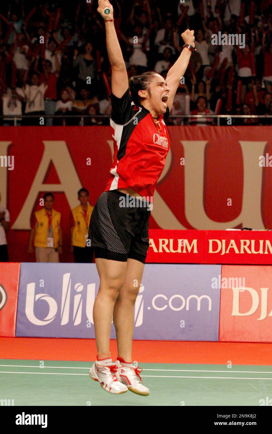 India's Saina Nehwal celebrates upon defeating China's Li Xuerui during ...