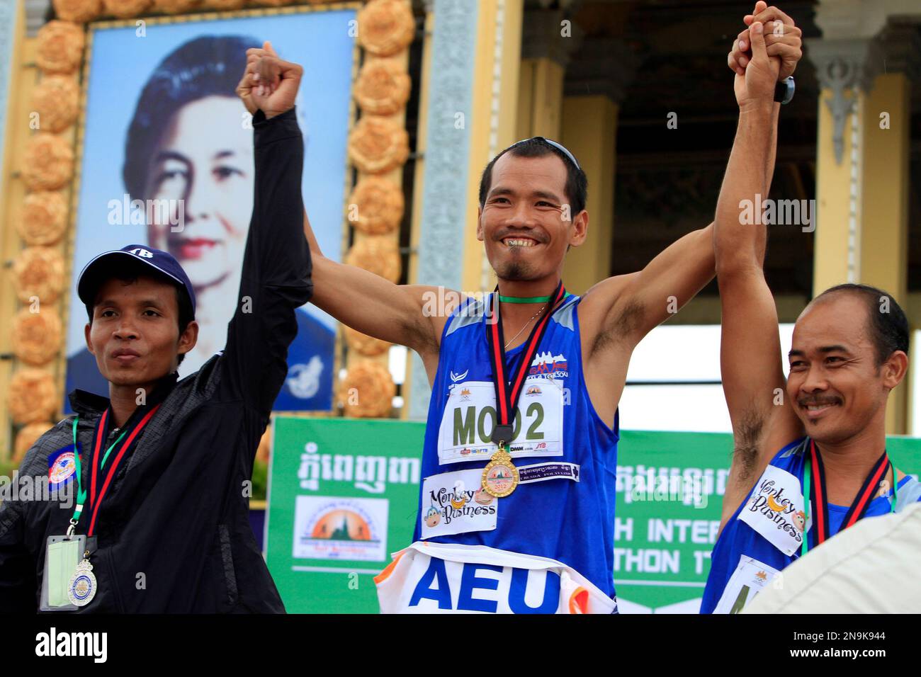 Cambodia half marathon first place winner Hem Buntin, center, is ...