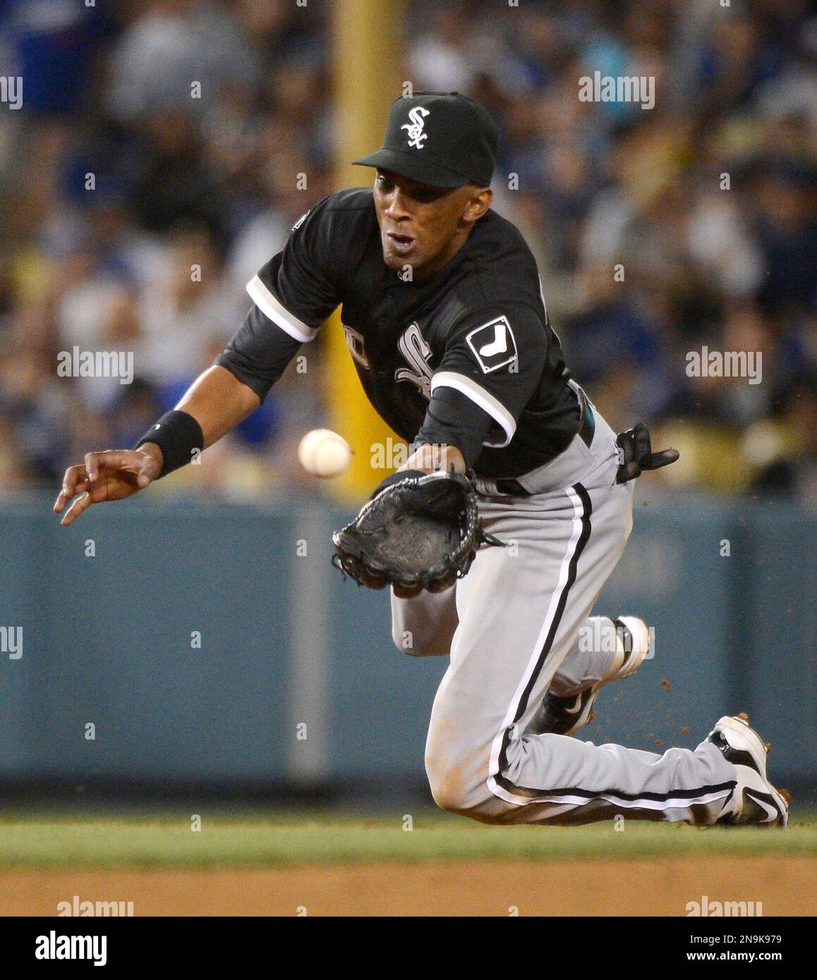 Chicago White Sox shortstop Alexei Ramirez dives as he catches a ball ...
