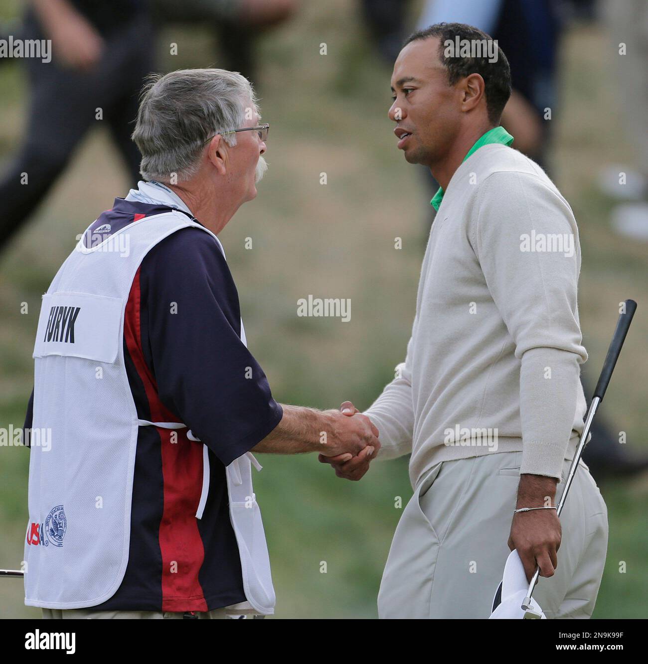 Tiger Woods shakes hands with caddie Mike 'Fluff' Cowan after the third ...