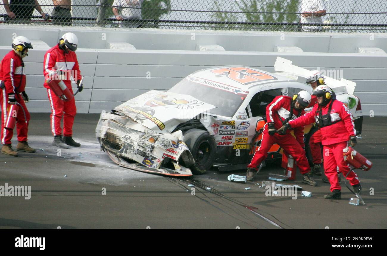 Track crews work on NASCAR driver Jamie Dick's car during the ...