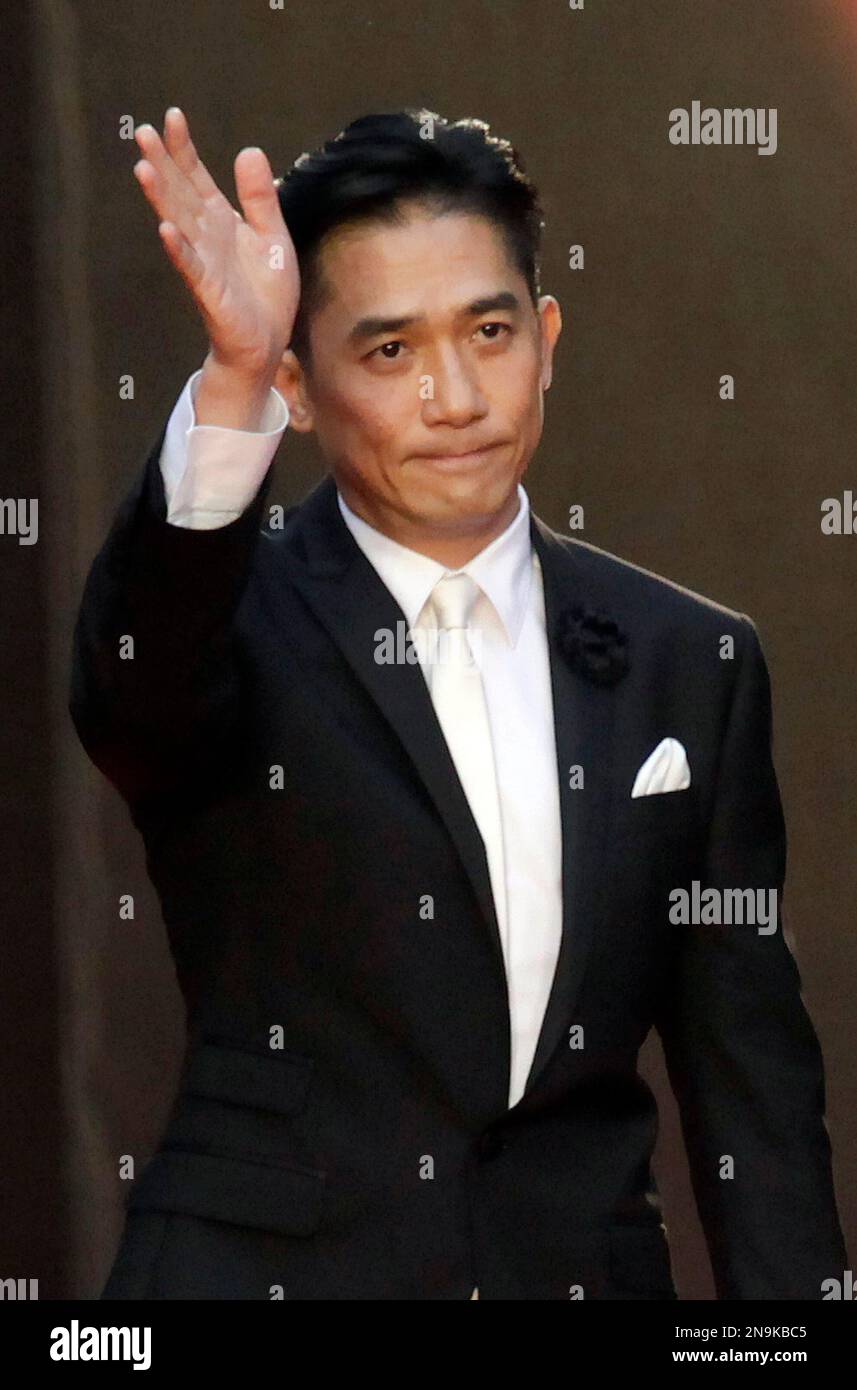 Hong Kong actor Tony Leung waves on the red carpet prior to the opening ...