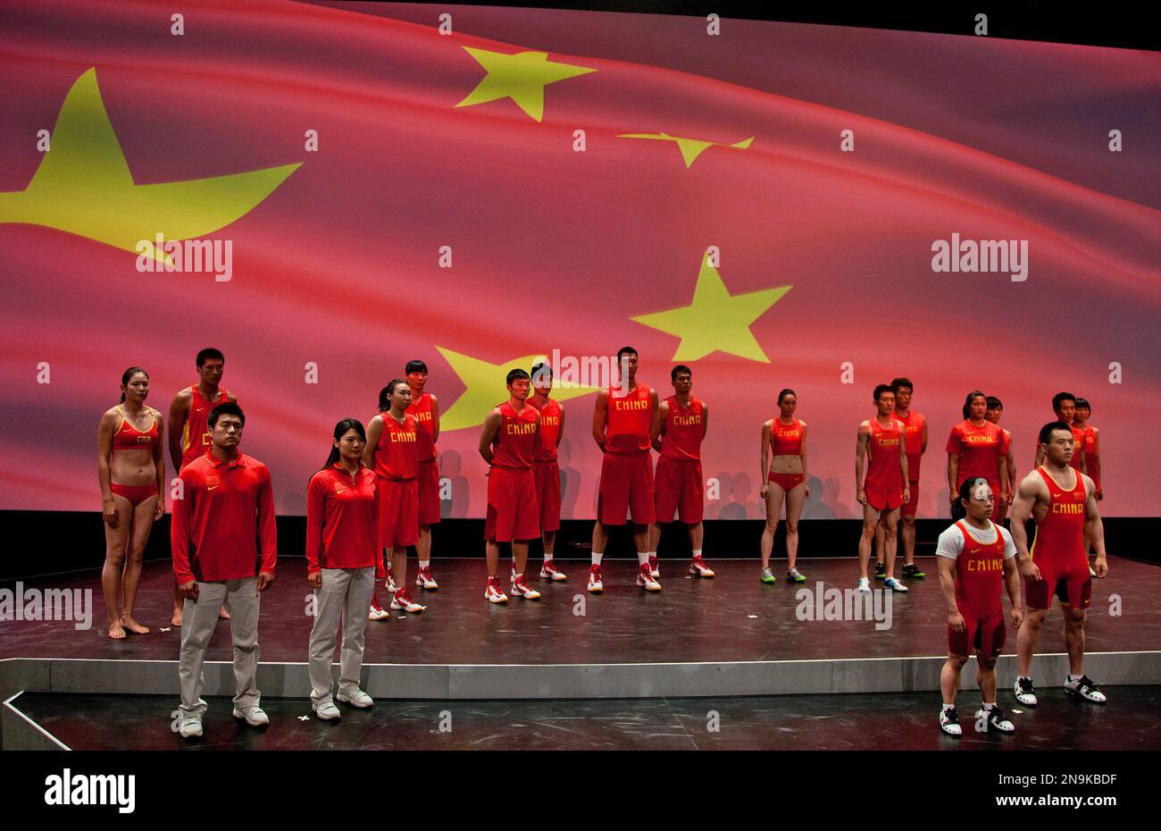 Chinese athletes stand on a stage as they unveil the Chinese national ...