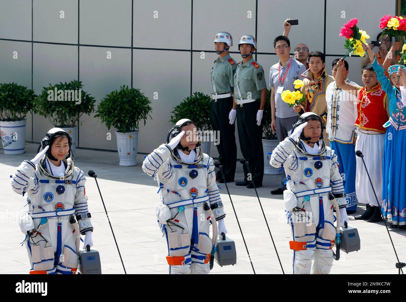 China's astronauts from left Liu Yang, Jing Haipeng and Liu Wang salute ...