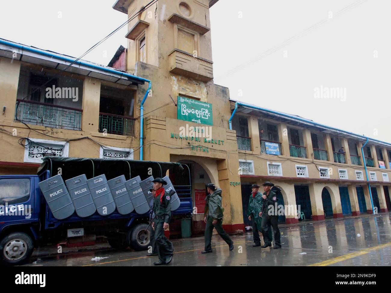 Myanmar soldiers patrol past a police truck parked near the main market ...