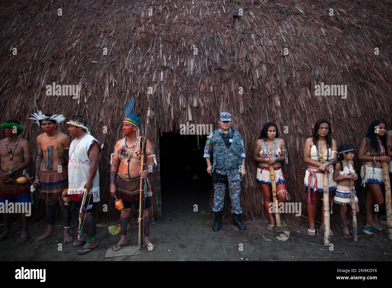 A National Force soldier stands with Guarani tribe members outside a ...