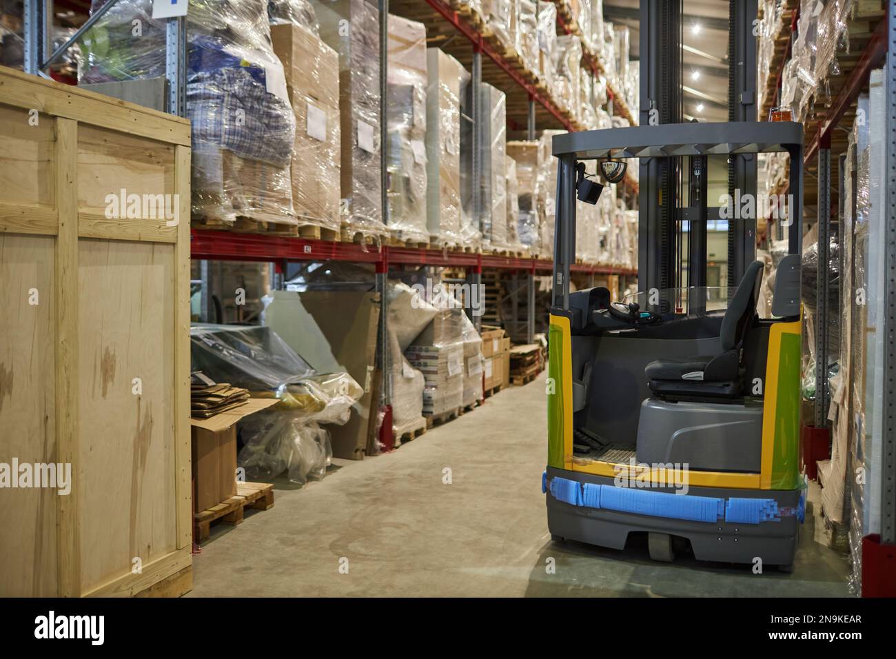 Background image of warehouse interior with forklift by tall shelves ...