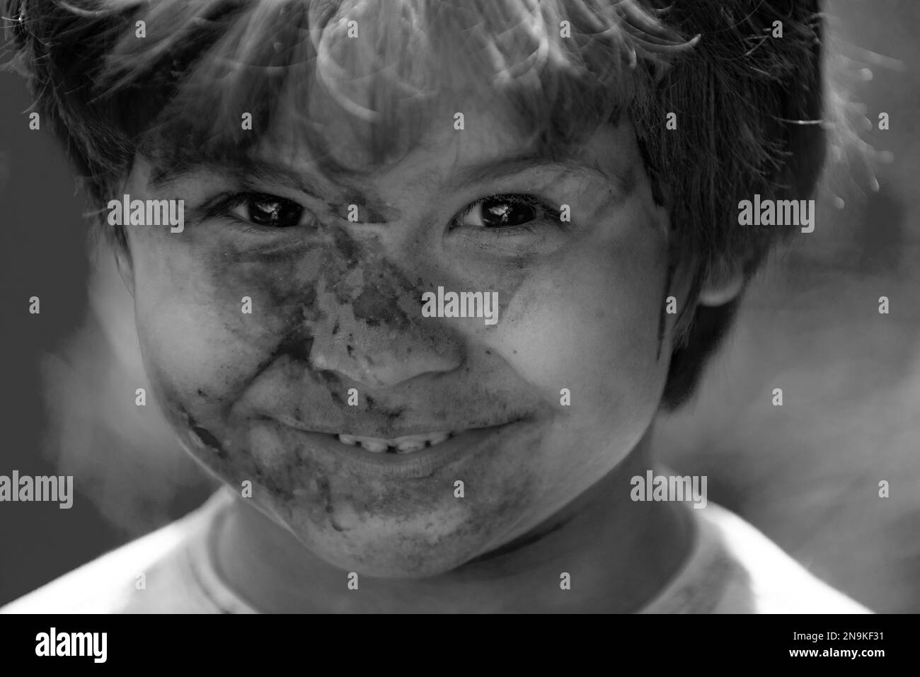 Holi festival child. Painted kid funny face. Little boy plays with ...