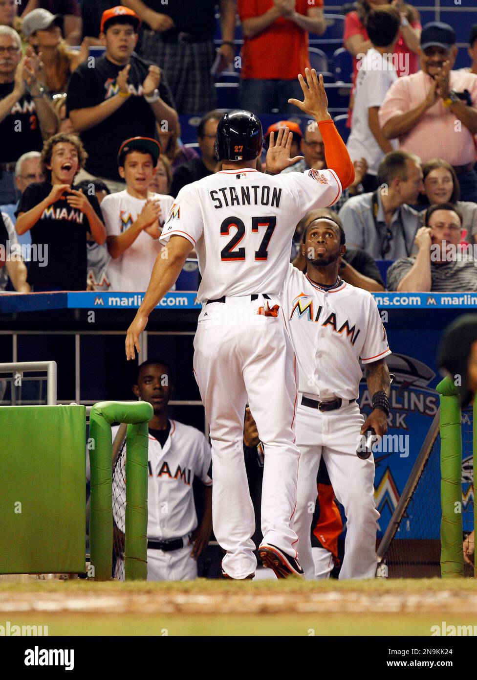 Miami Marlins' Giancarlo Stanton (27) is met by Jose Reyes after ...