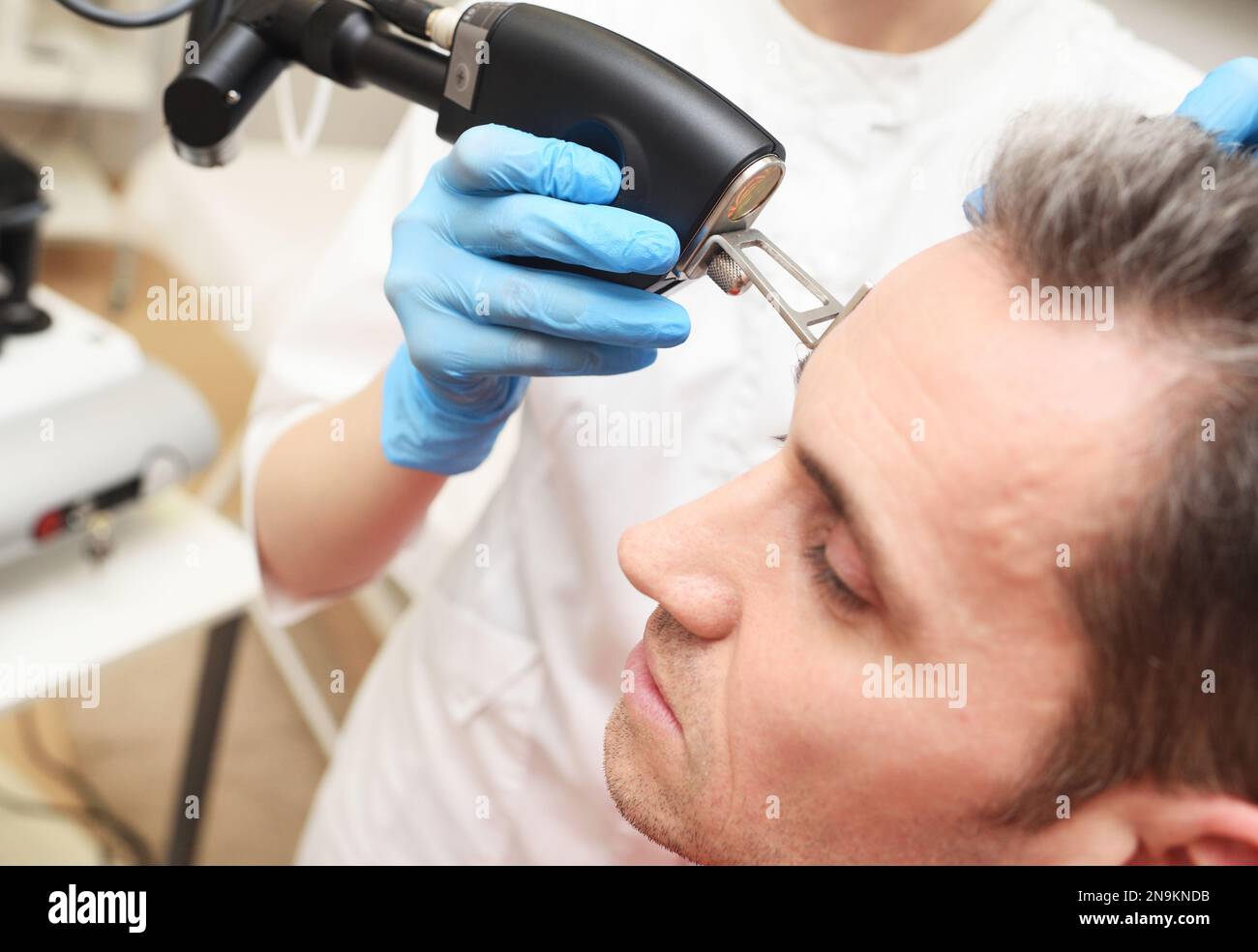 cosmetologist uses a CO2 fractional ablative laser to rejuvenate the ...