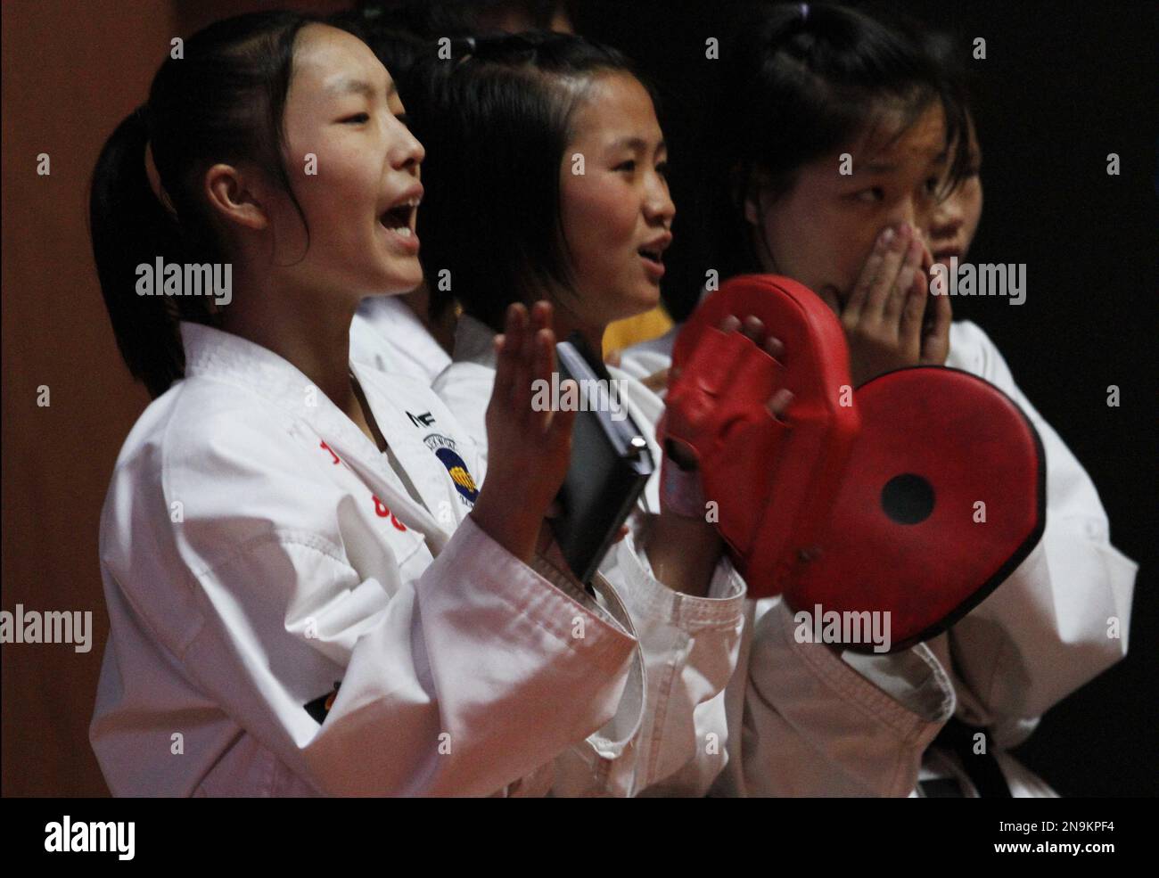North Korean Taekwondo athletes cheer from the crowd during the 15th ...