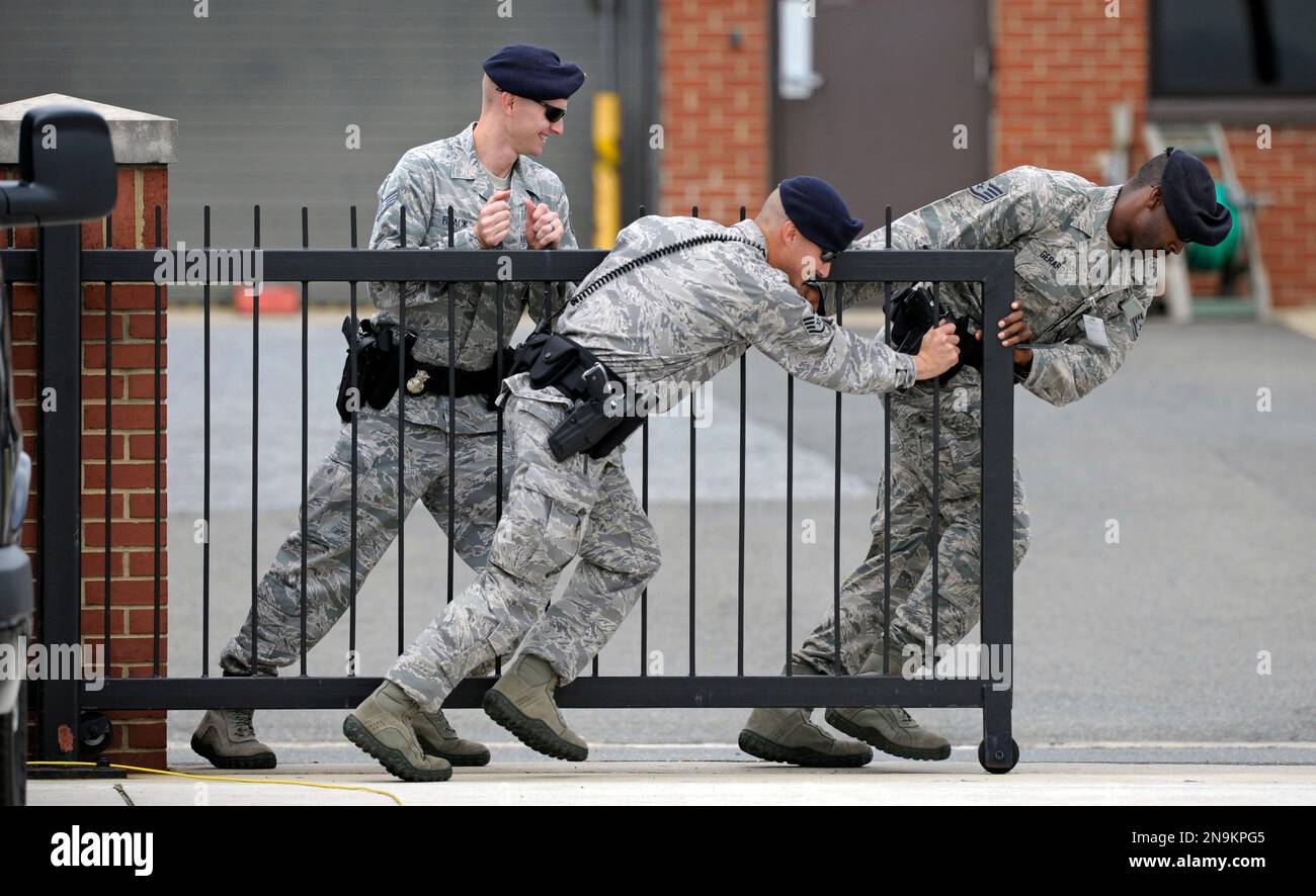 Air Force security forces close a gate to the tarmac in preparation of ...