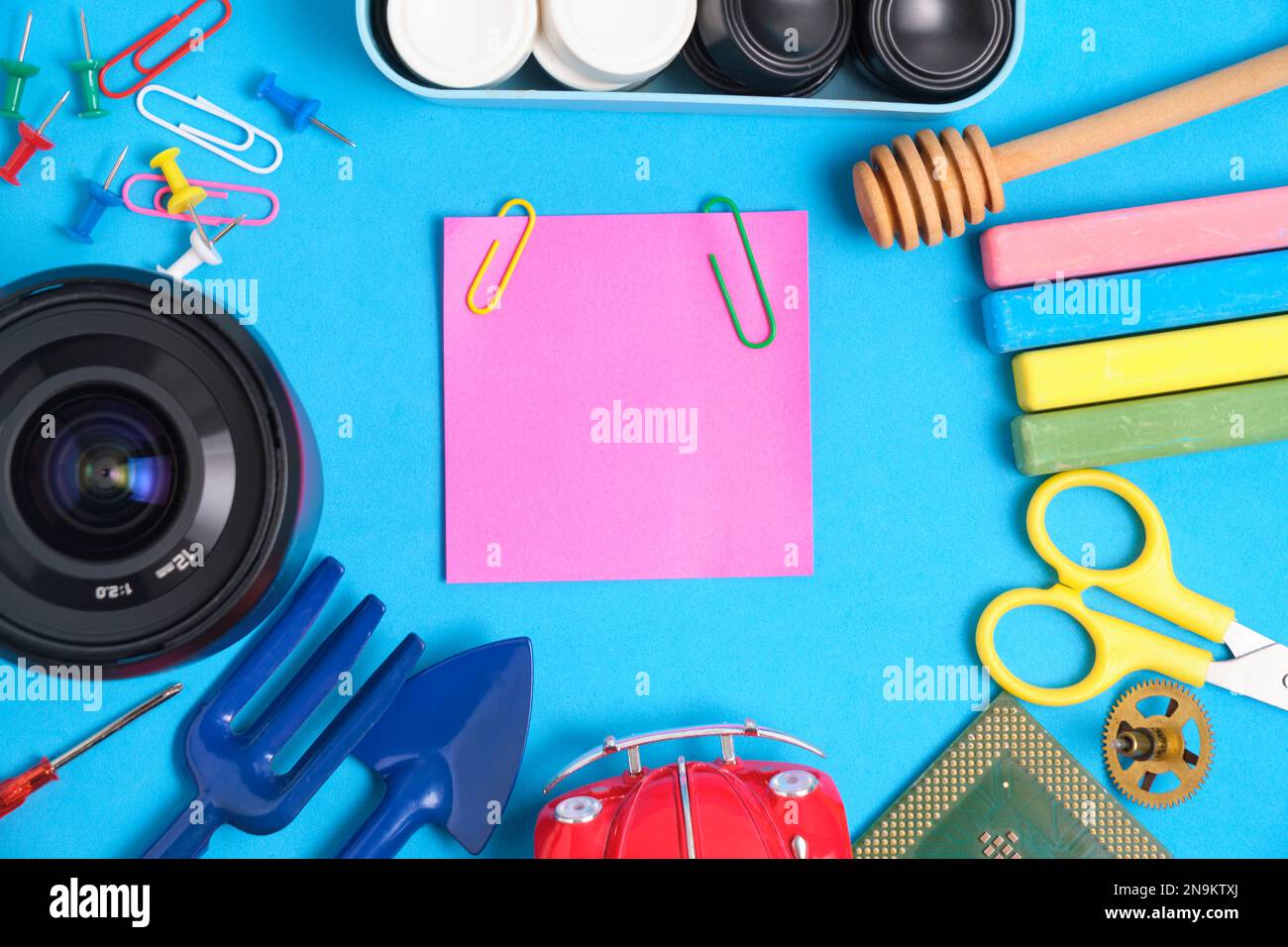 Pink paper sticker blue background in center of a variety things for ...