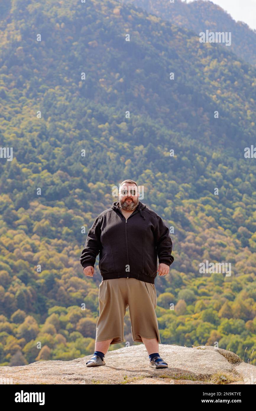 The fat man stands on the top of the mountain Stock Photo - Alamy