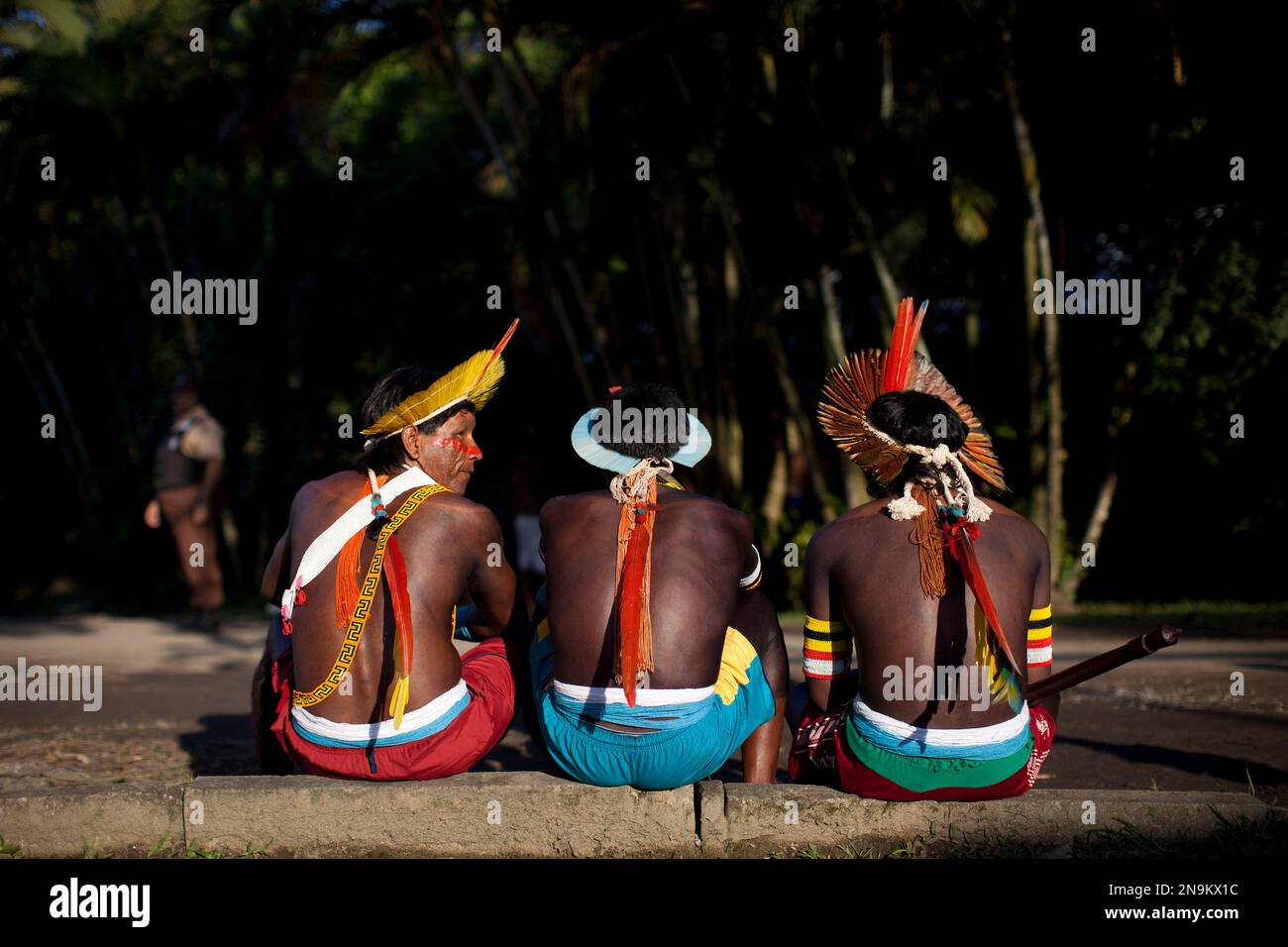 Caiapo tribe members sit on a curb at the Kari-Oca village, where ...