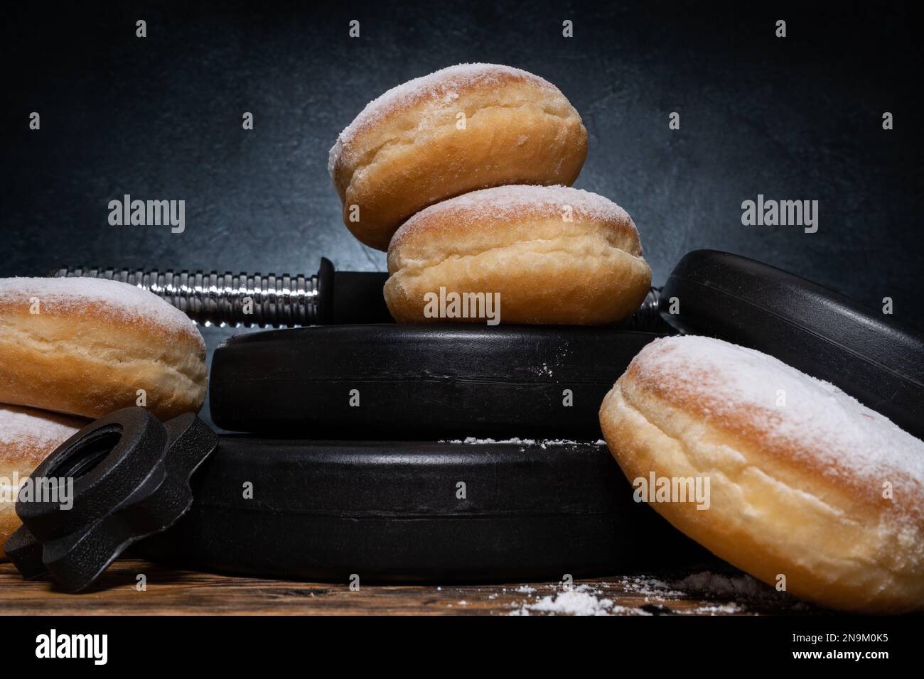 Gym dumbbells barbell weight plates and Polish pączki deep-fried ...