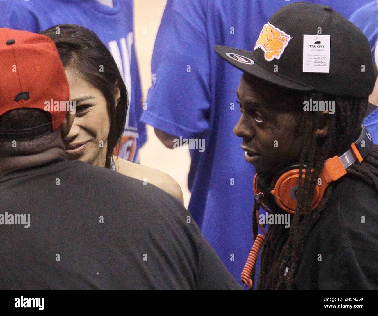 Entertainer Lil Wayne visits with other fans during halftime at Game 1 ...