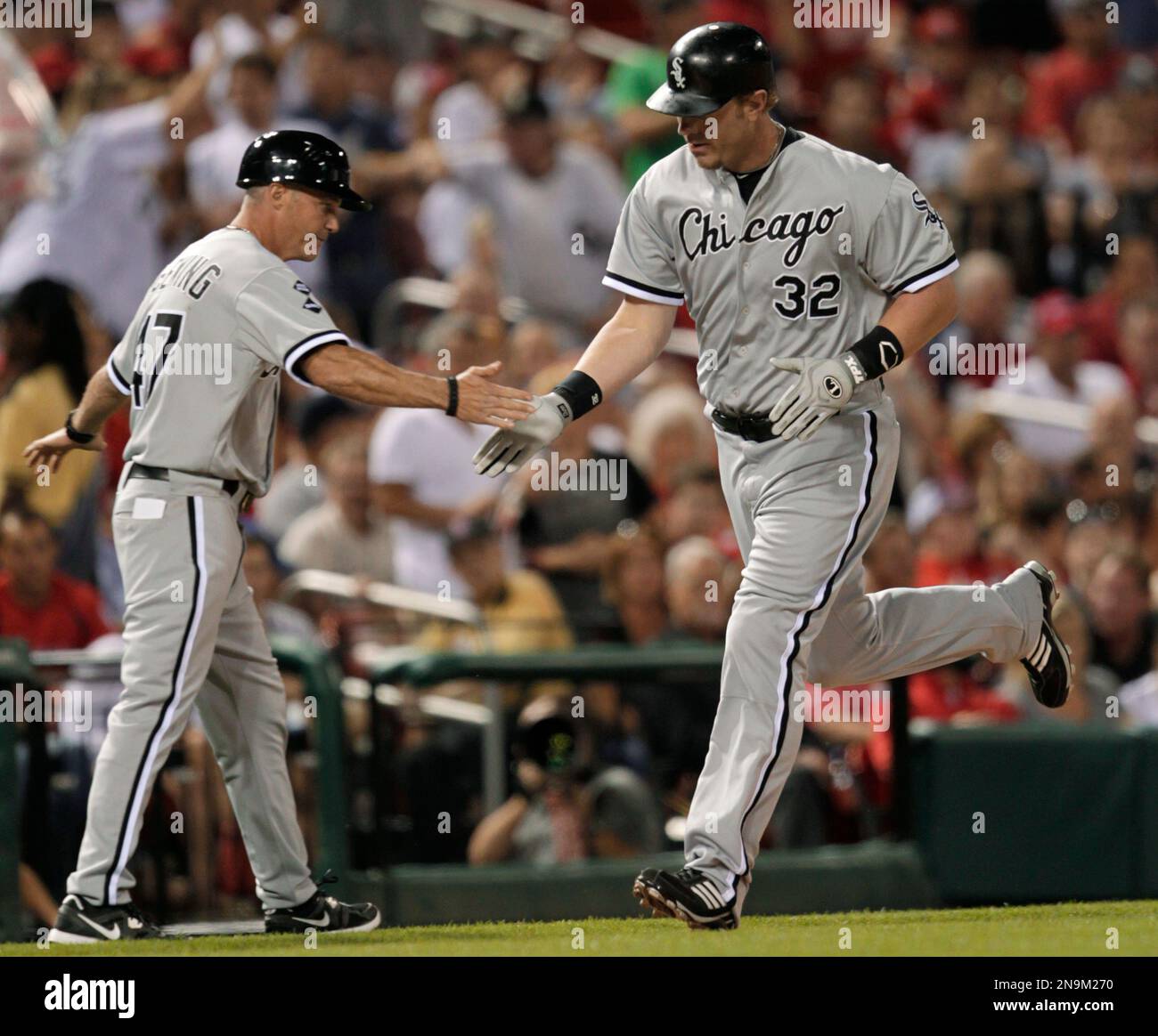 Chicago White Sox's Adam Dunn (32) celebrates with third base coach Joe ...