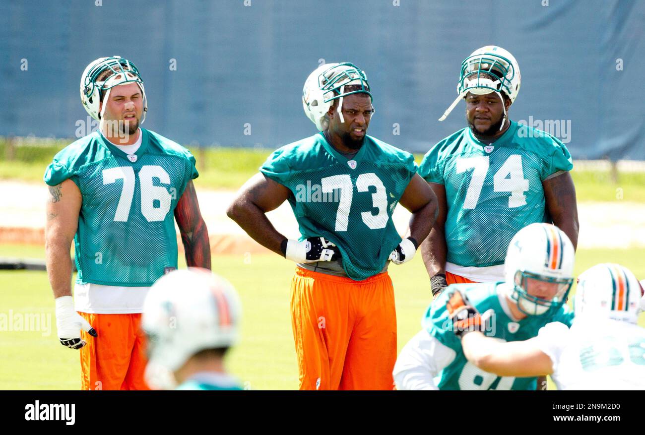 Miami Dolphins players Lydon Murtha (76), Artis Hicks (73) and John ...