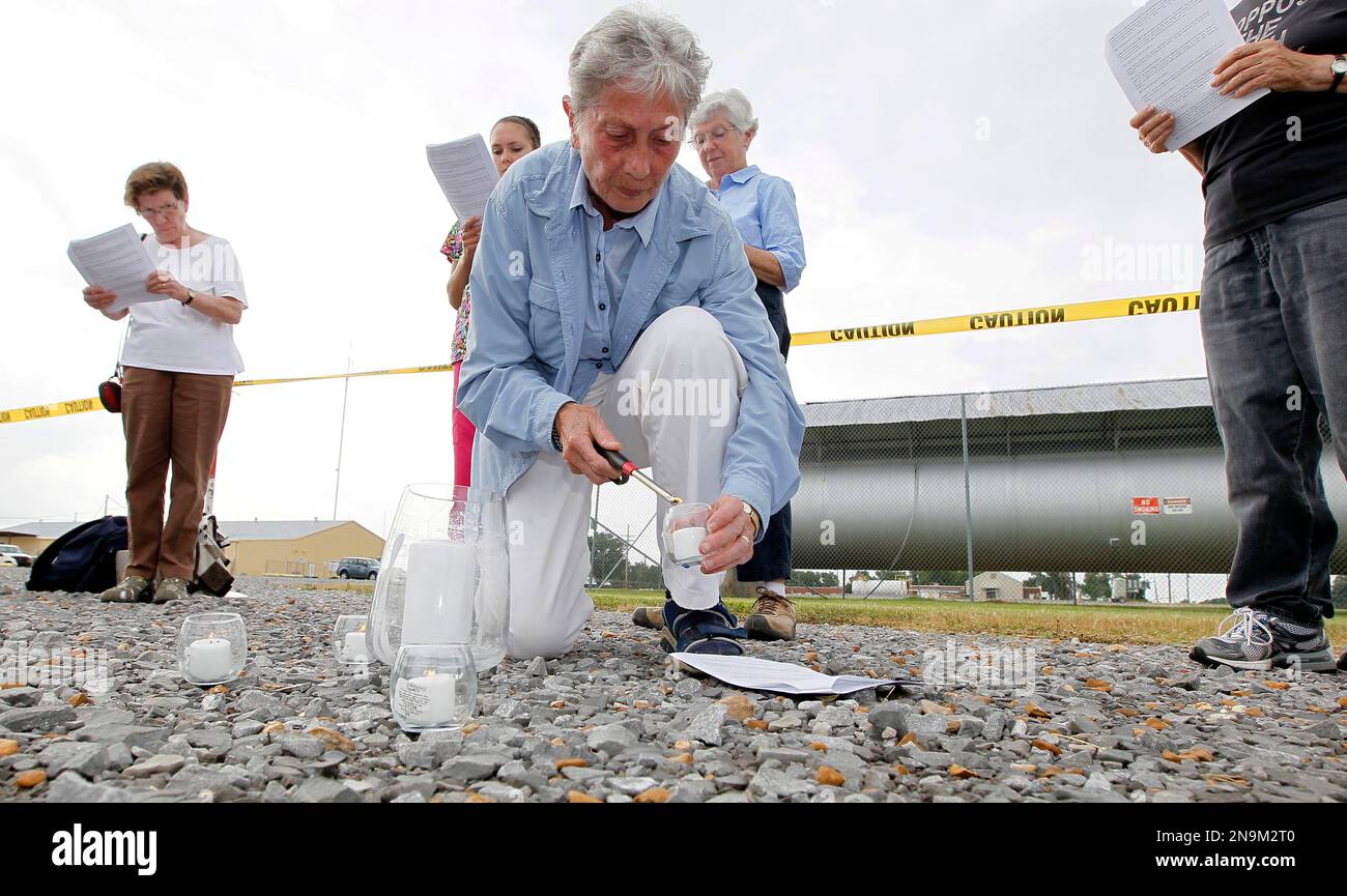 Death penalty opponent Sister Kay Burton of Jonestown, Miss., lights a ...