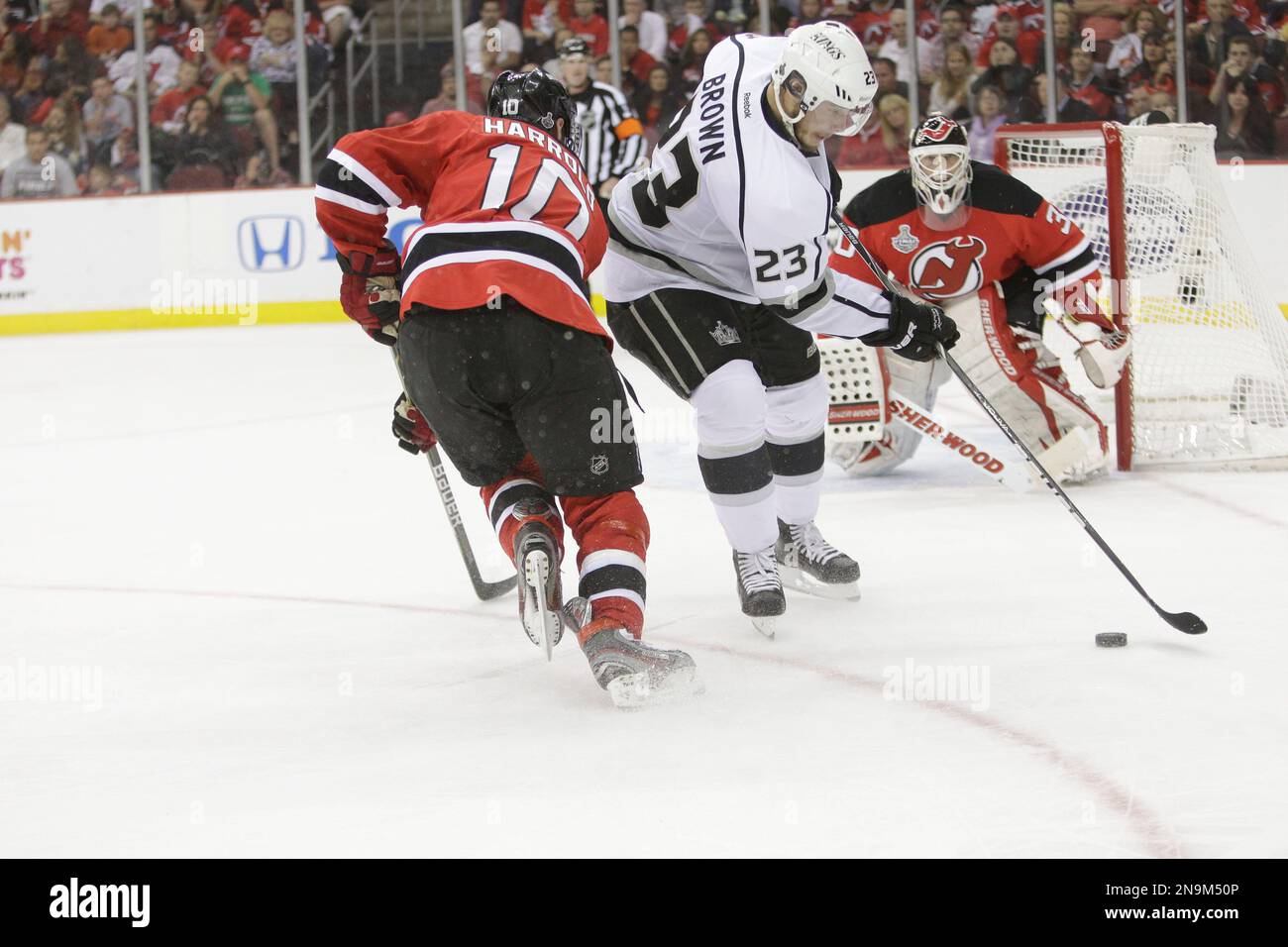 Los Angeles Kings right wing Dustin Brown (23) works around New Jersey ...