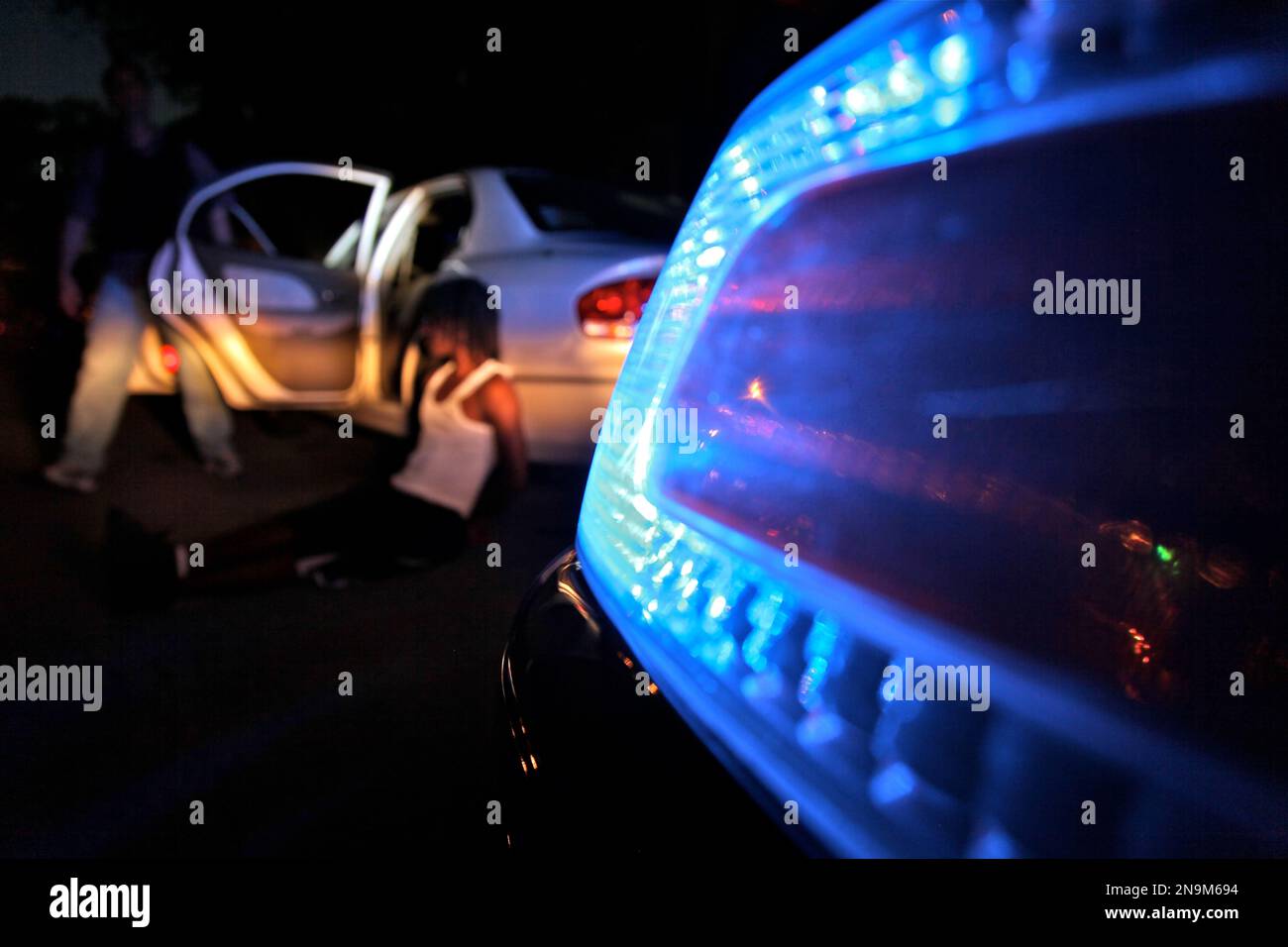 In a June 9, 2012 photo, the Chicago Police gang enforcement unit stops ...