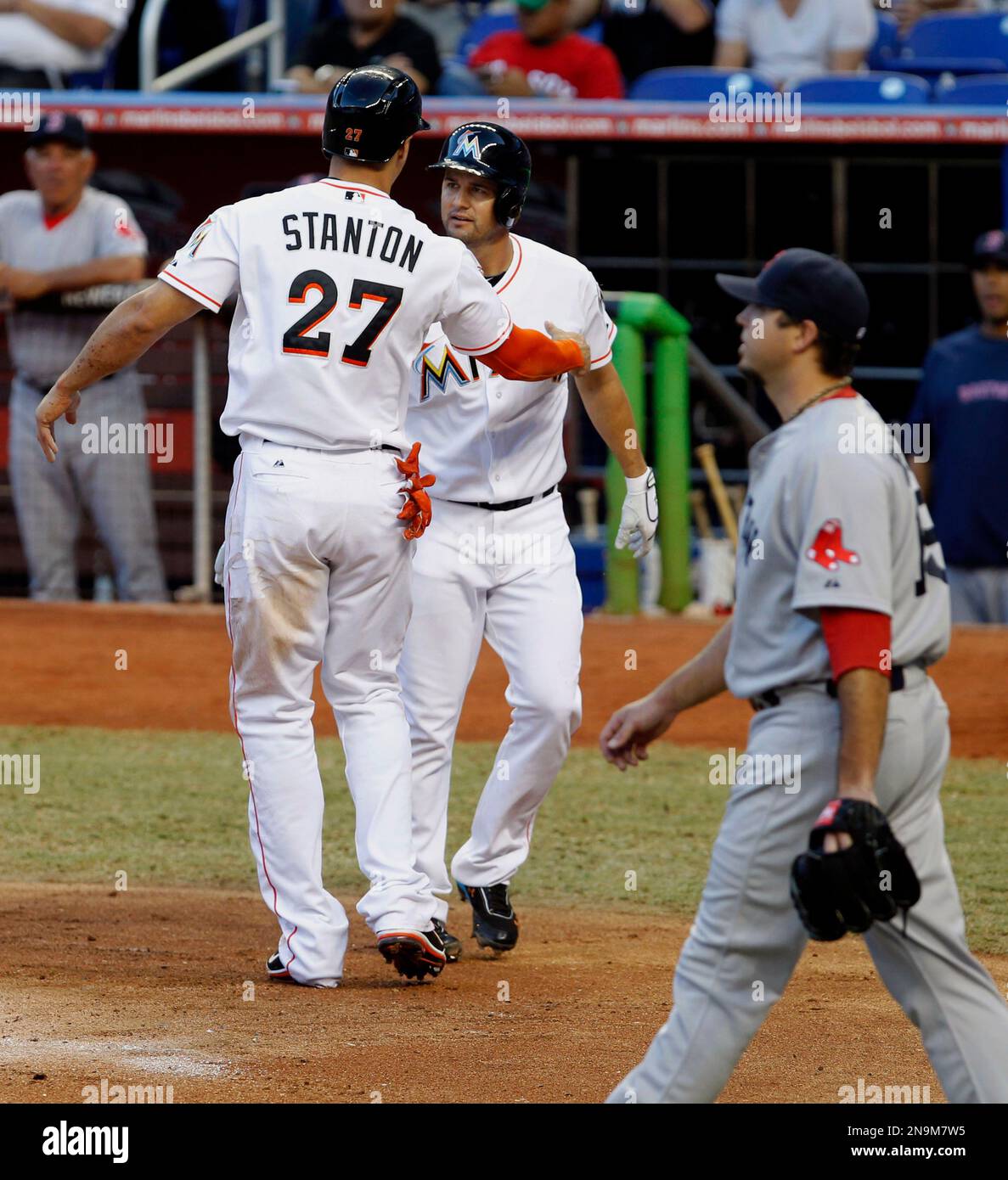 Miami Marlins' Giancarlo Stanton (27) is greeted by teammate Chris ...